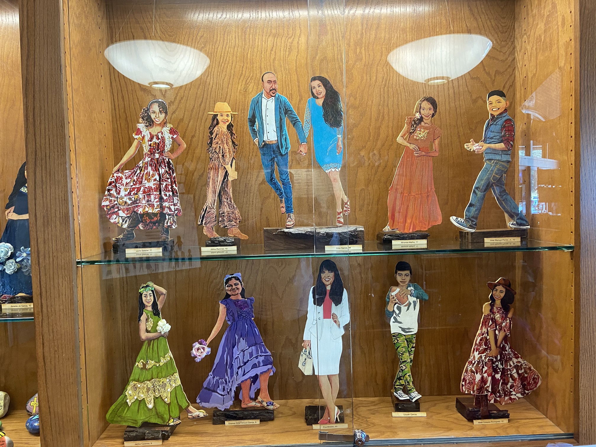 Artist Kimberly Morgan presents wood figurines representing each of the ...